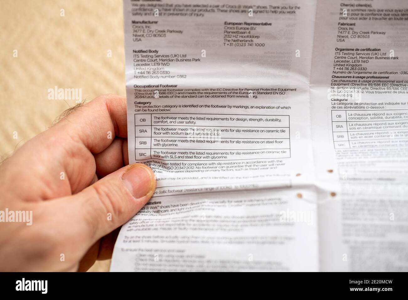 Paris, France - Dec 13, 2020: POV male hand reading Crocs at work ...