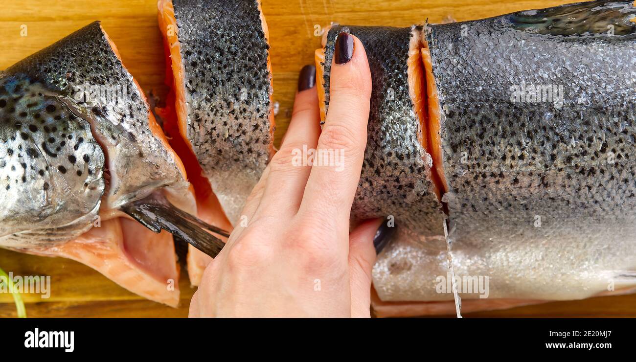 Cutting salmon fresh fish for dinner. diy cooking at home Stock Photo ...