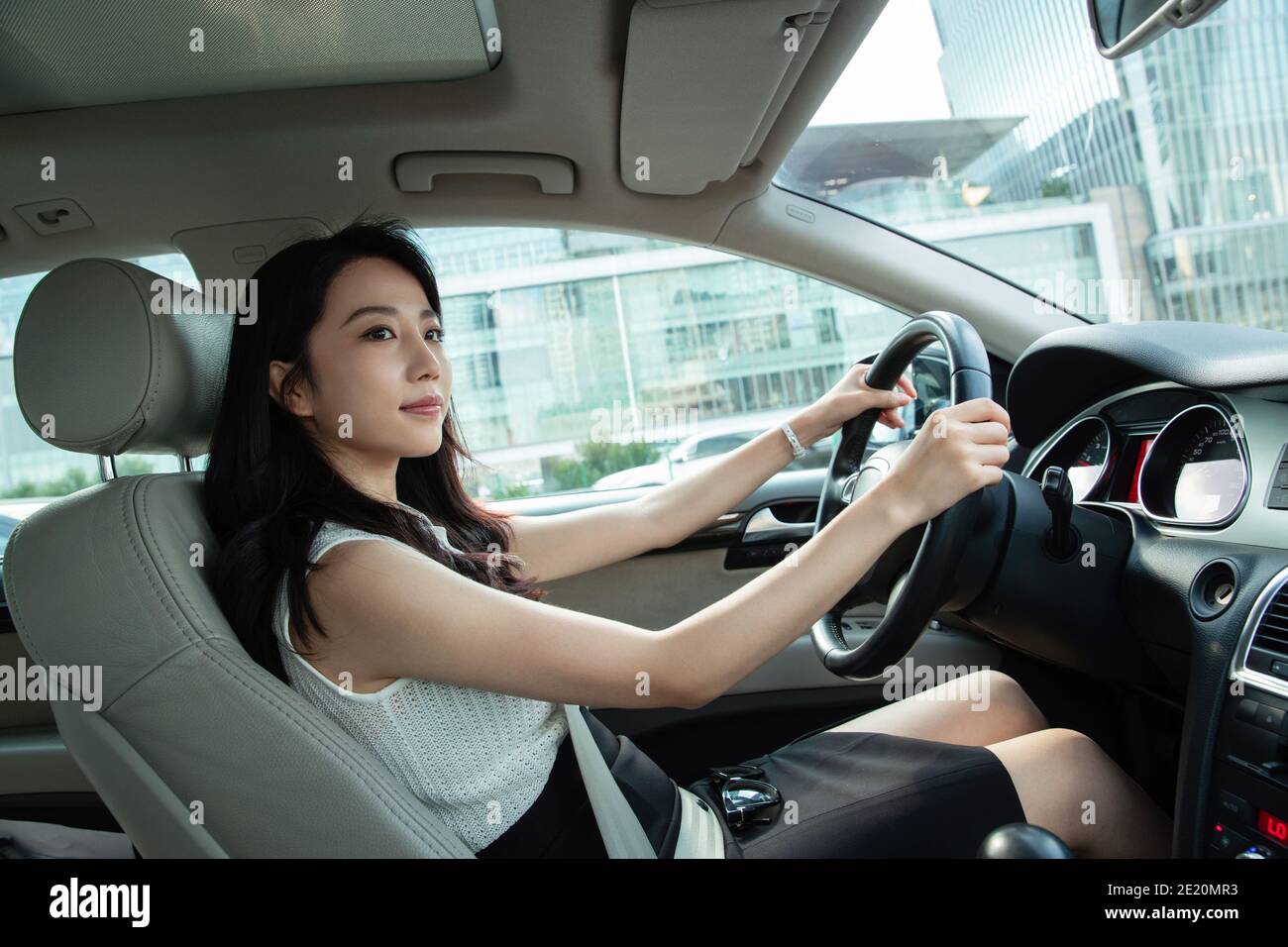 A beautiful young woman driving a car Stock Photo - Alamy