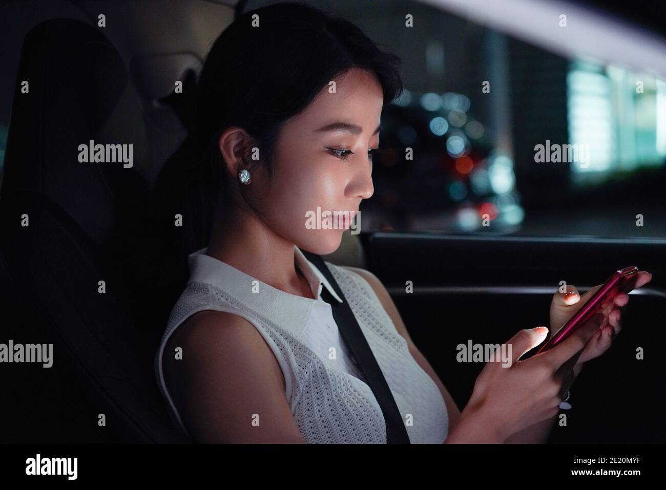 Night young women use a mobile phone in the car Stock Photo - Alamy