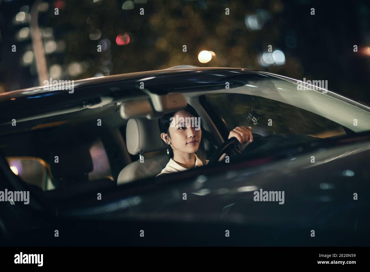 Woman driving car night hi-res stock photography and images - Alamy