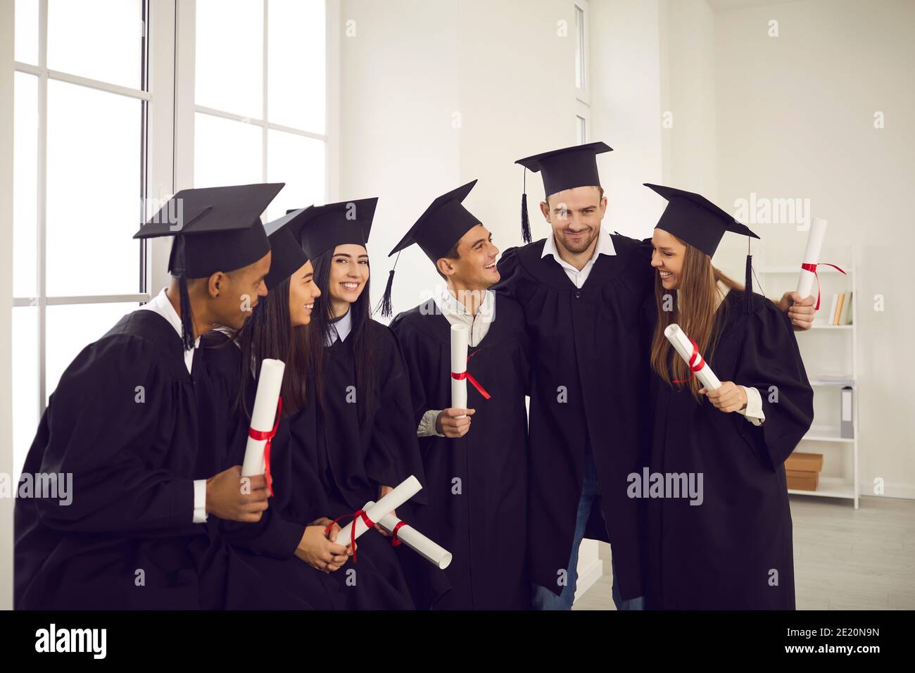 Group of happy international university students with diplomas ...