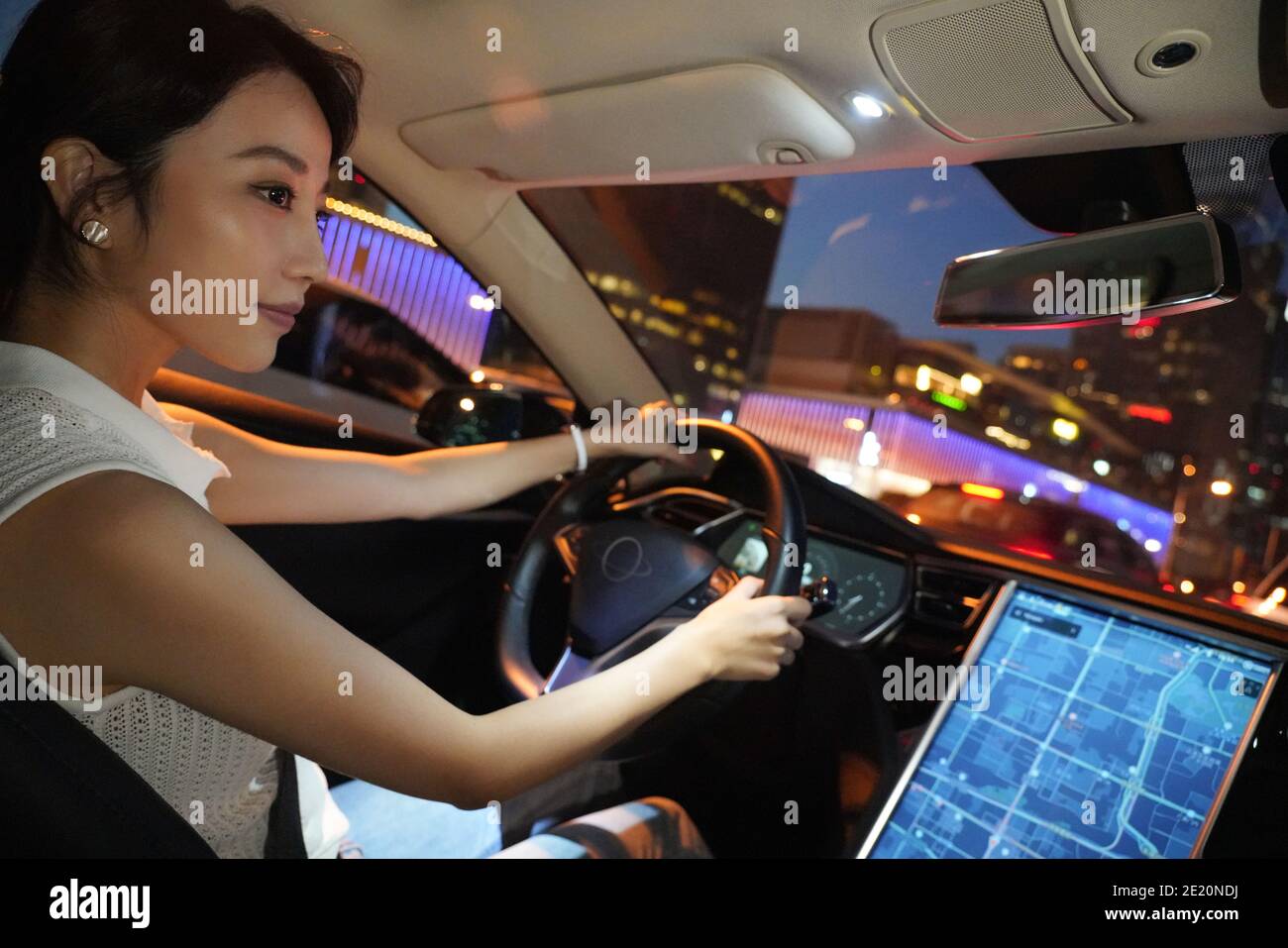 Driving at night young woman Stock Photo - Alamy