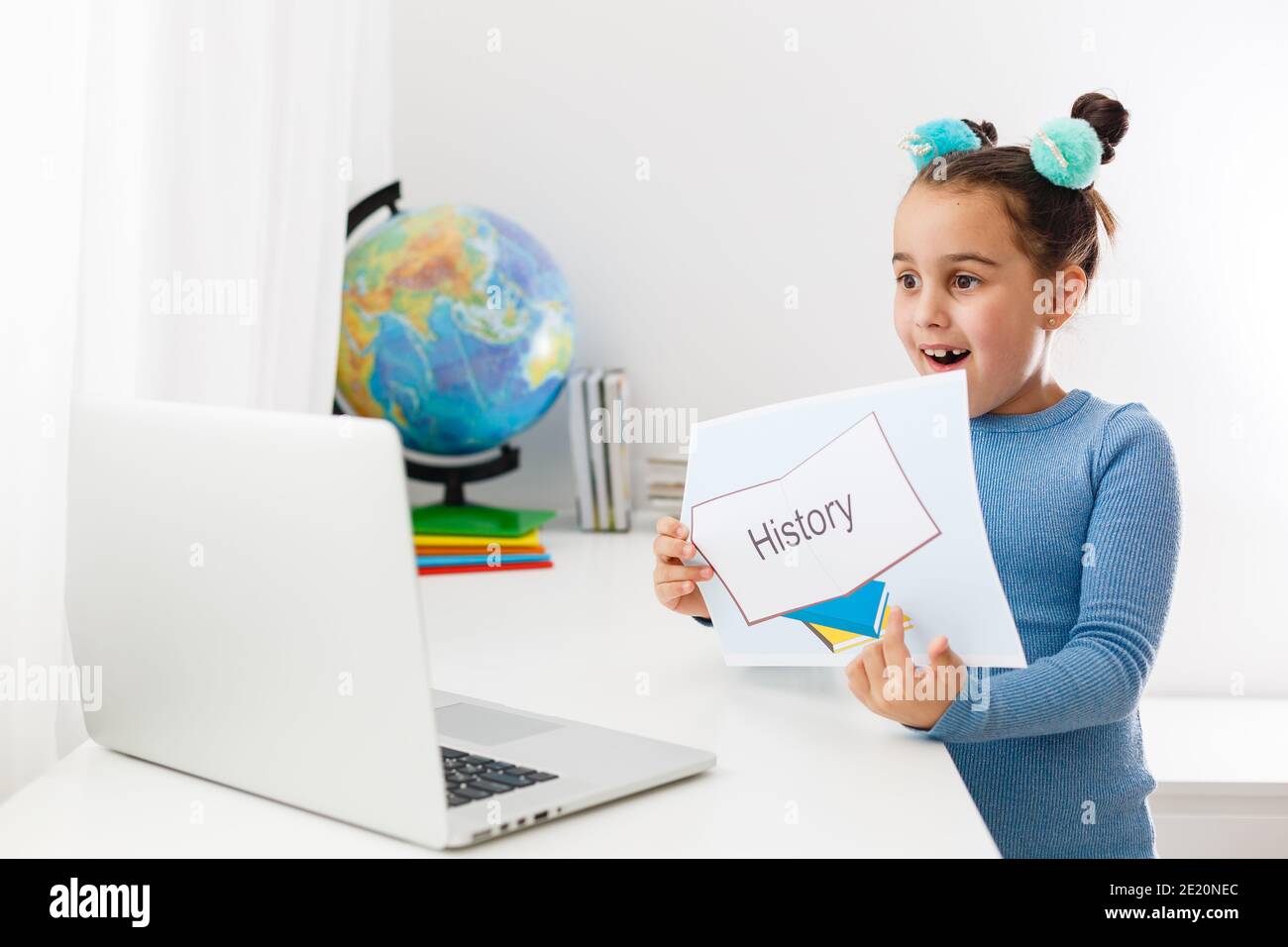 little girl learning history on laptop online Stock Photo - Alamy