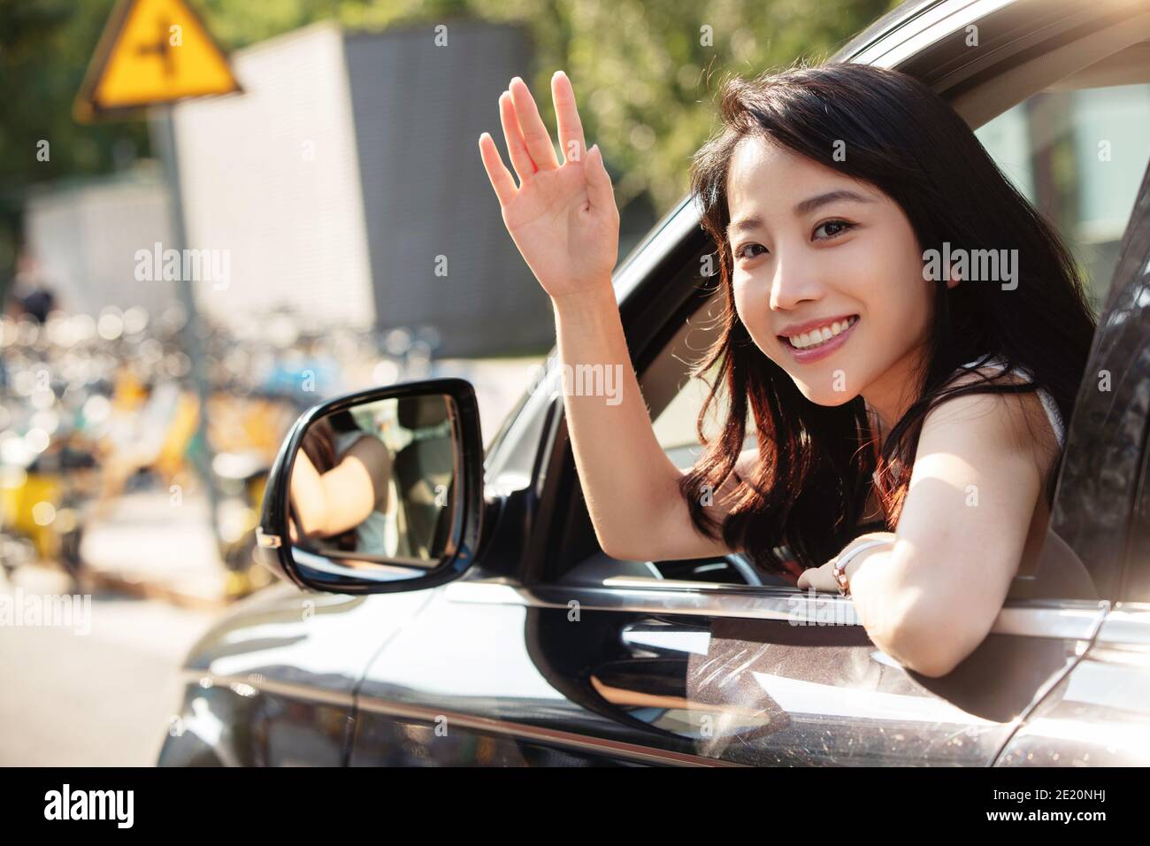 Say "hello" to drive young woman Stock Photo - Alamy