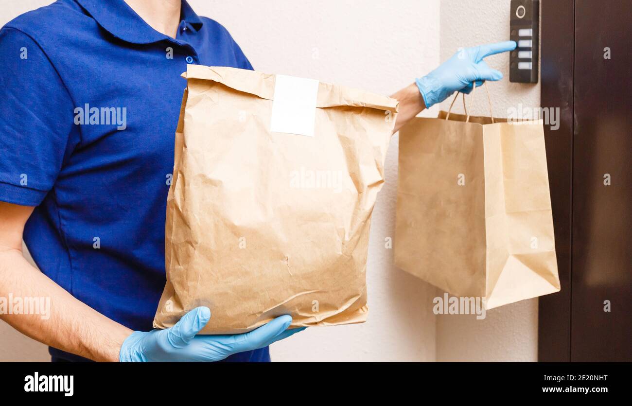 Diverse of paper containers for takeaway food. Delivery man is carrying ...
