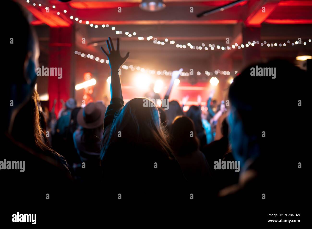 Photo of many people enjoying rock concert in nightclub Stock Photo - Alamy