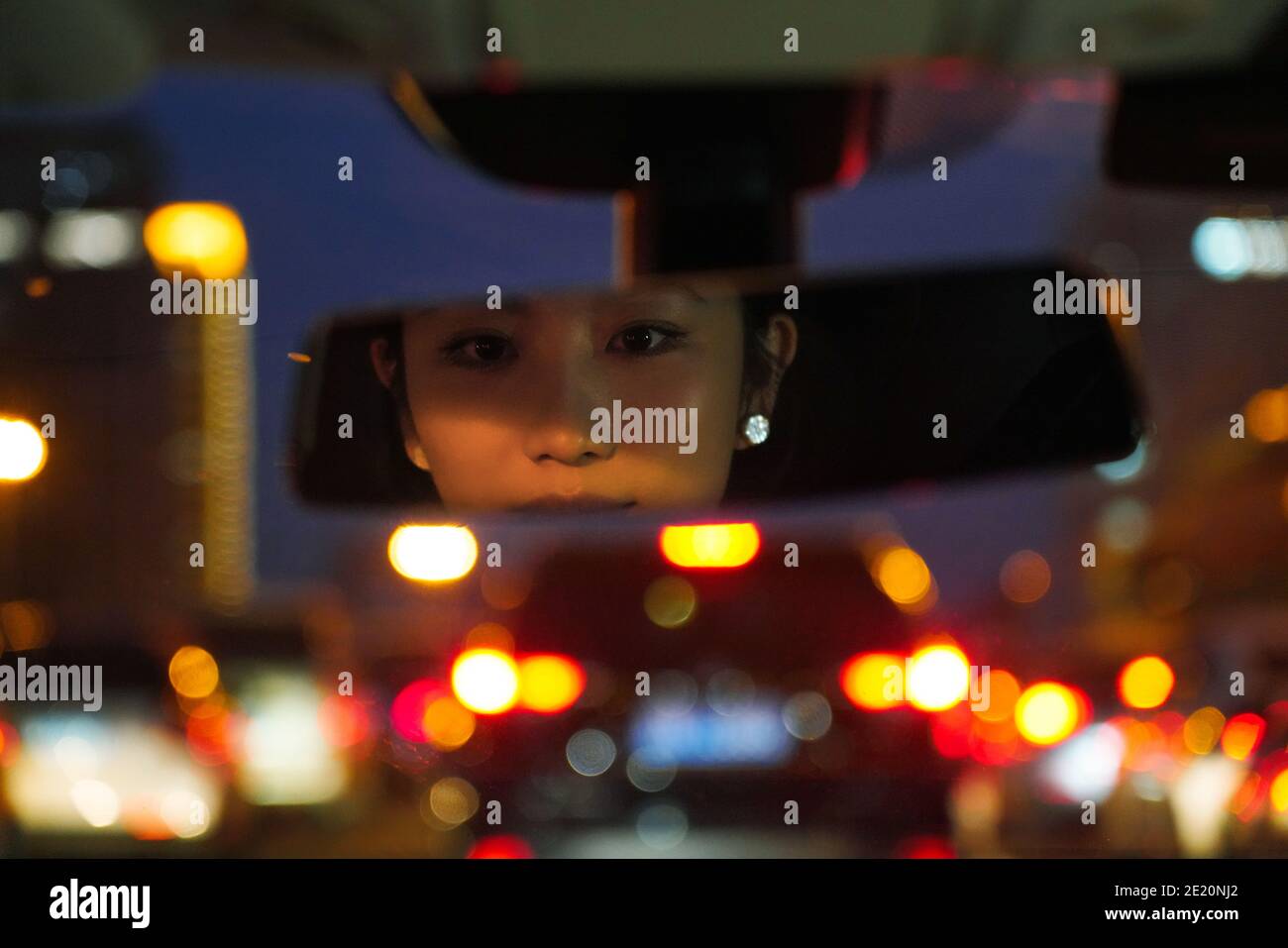 Car rearview mirror display of young women Stock Photo - Alamy