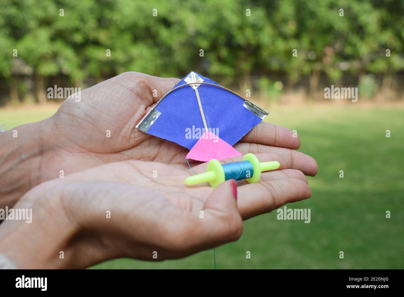 Female, woman, girl flying a miniature toy kite with miniature cute toy ...