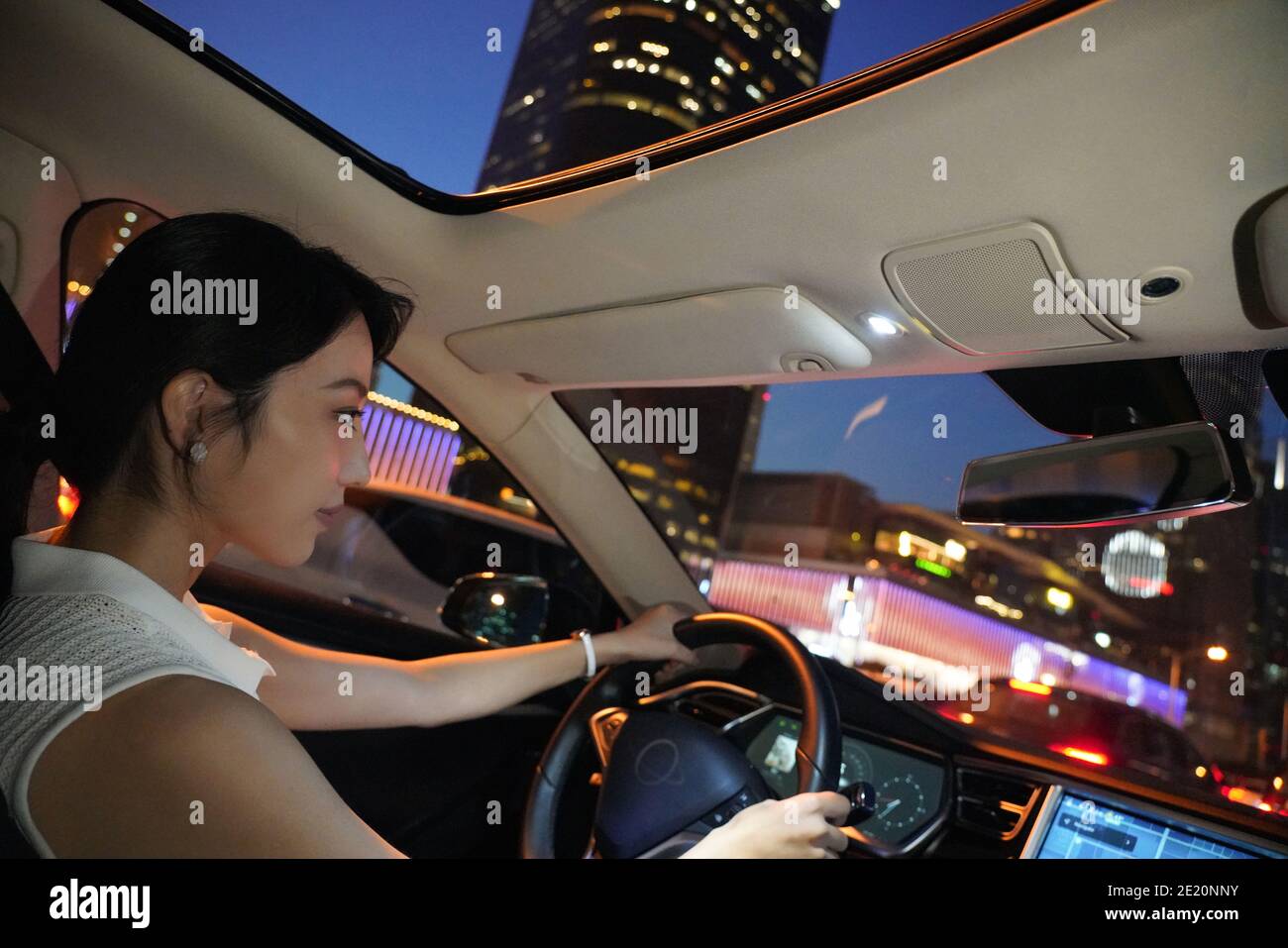 Driving at night young woman Stock Photo - Alamy