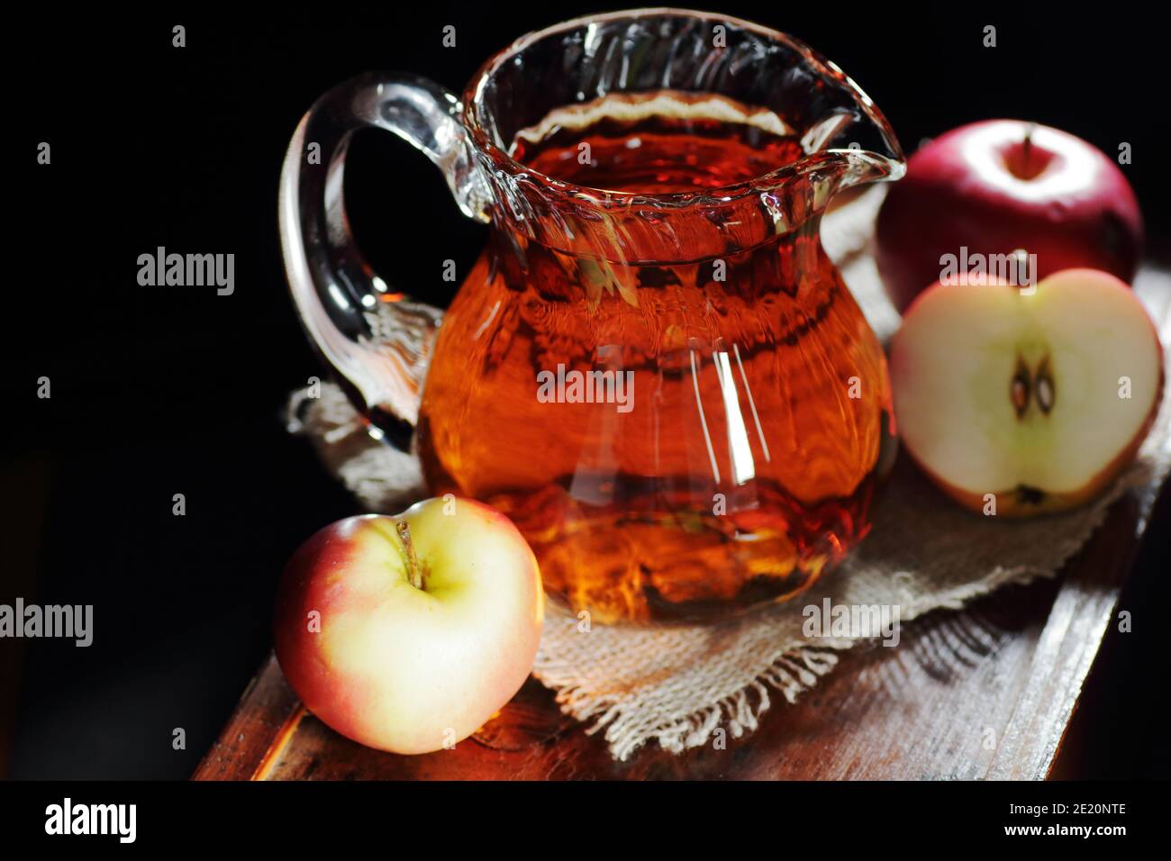 Apple vinegar, malt fruit cider drink in a glass decanter on dark black ...
