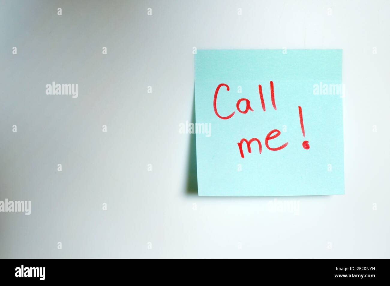 Call me written by hand and put on the white wall Stock Photo - Alamy
