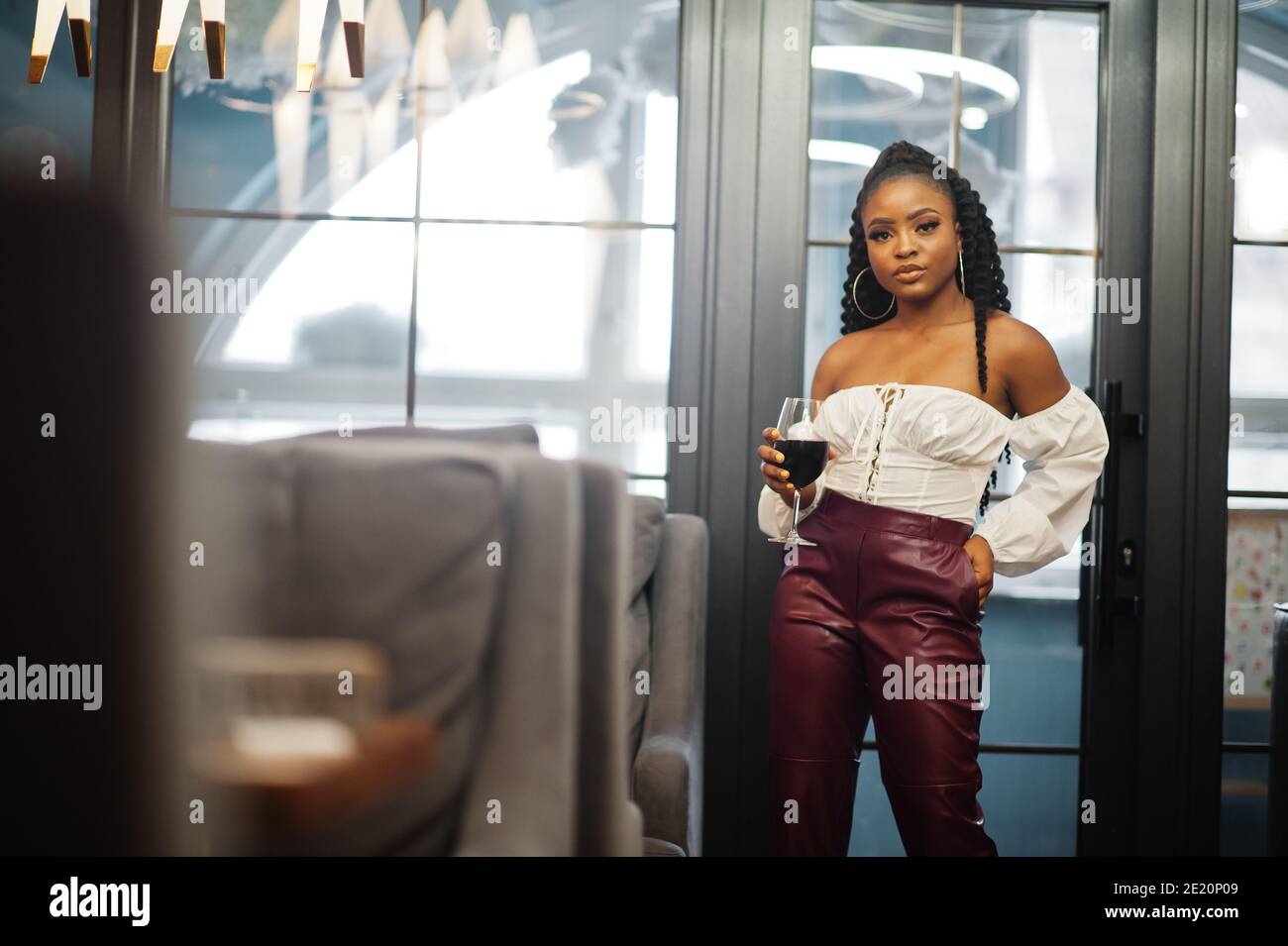 Beautiful african american woman in white blouse and red leather pants ...