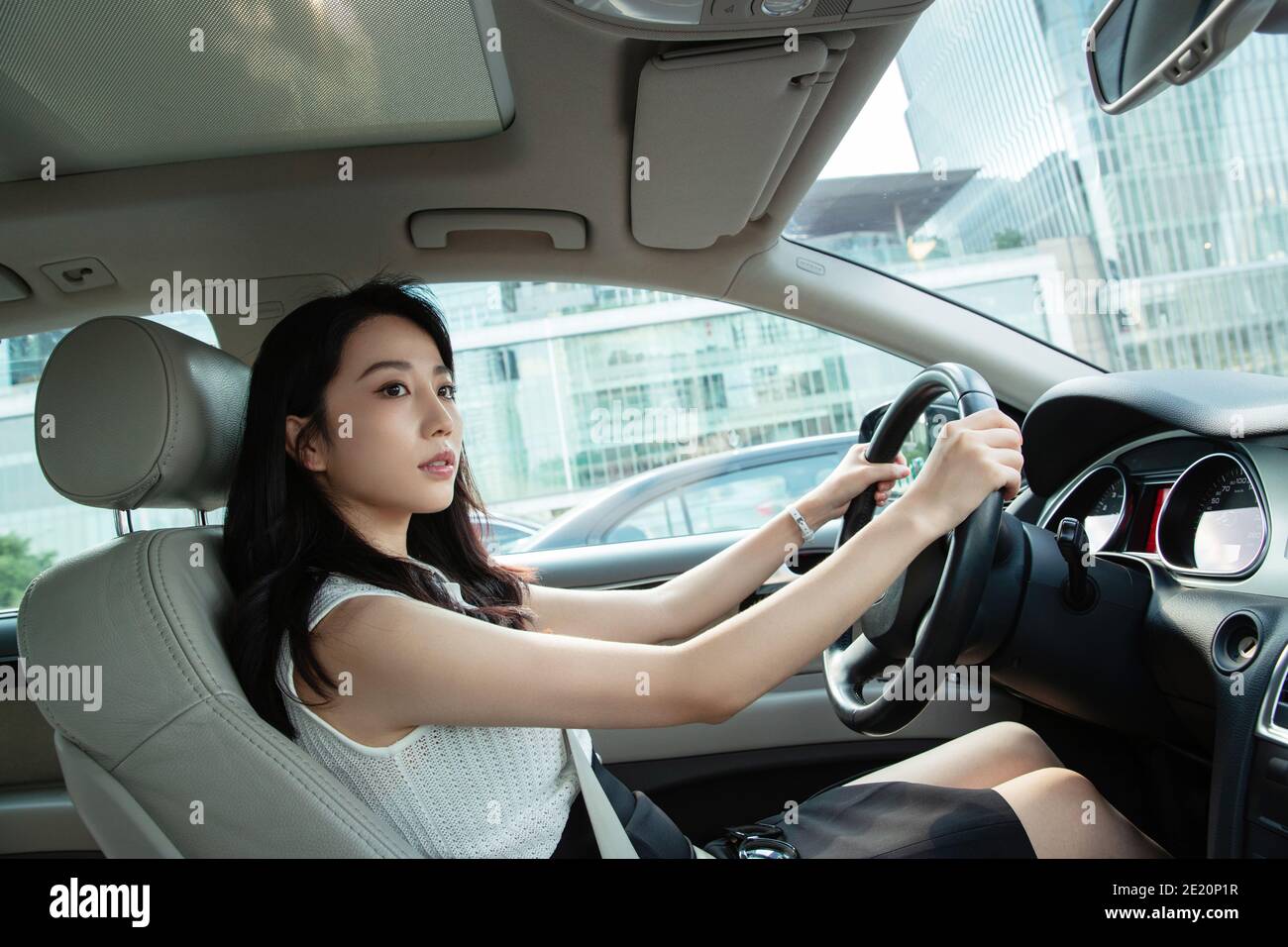 A beautiful young woman driving a car Stock Photo - Alamy