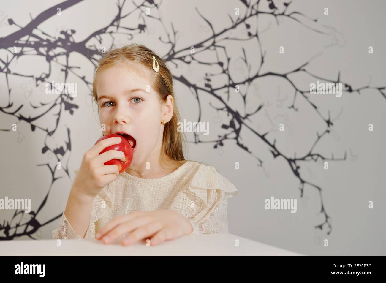 White girl (child, kid) eating an red apple. Copy space text Stock ...