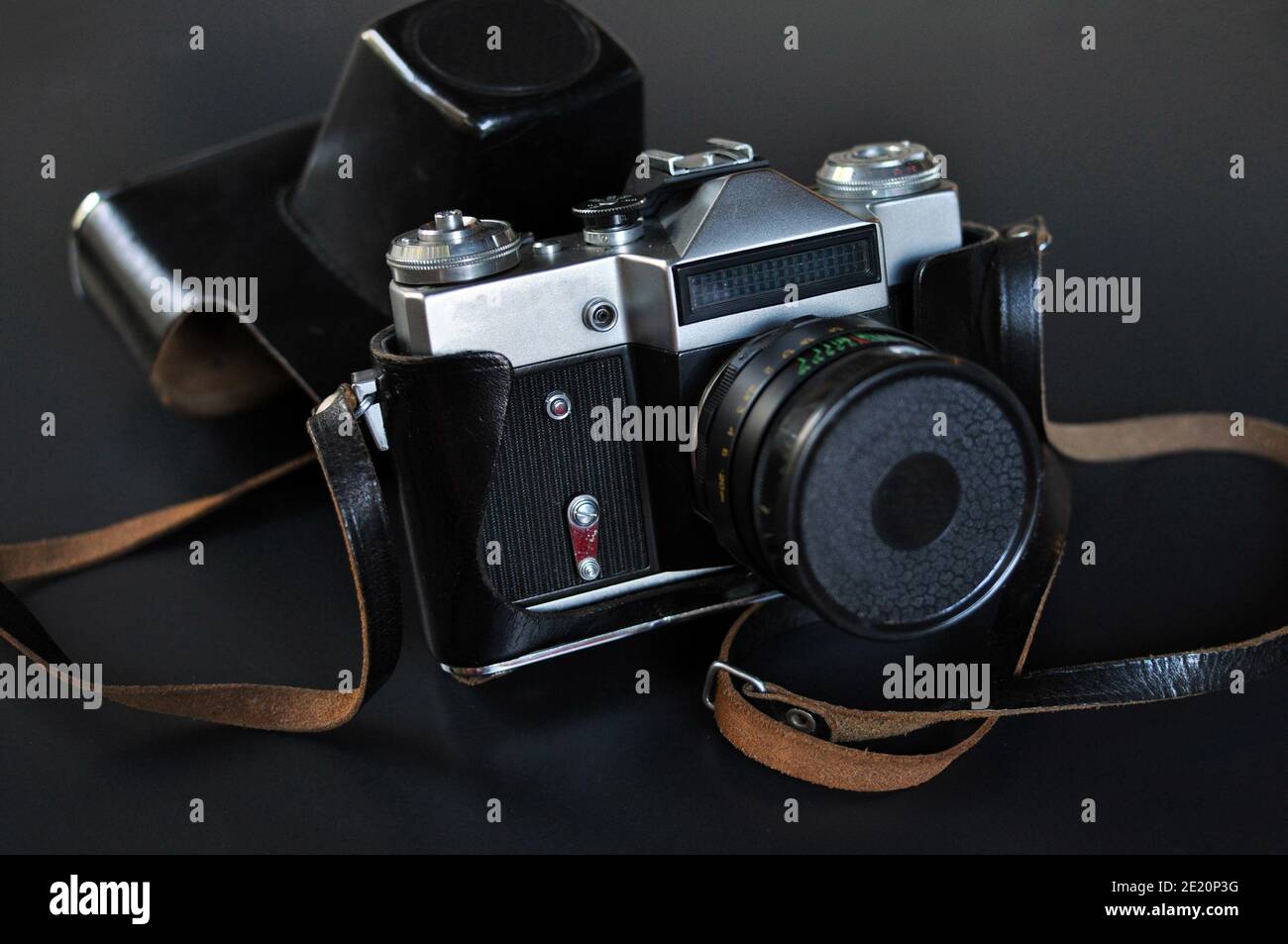Vintage old film photo camera with black leather case, on black ...