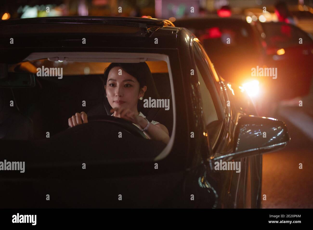 Driving at night young woman Stock Photo - Alamy