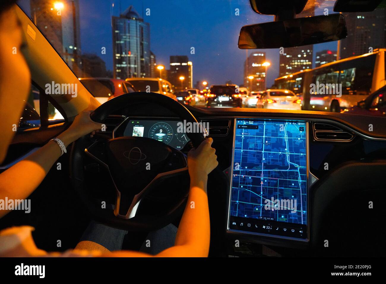 Night driving young woman look at the screen navigation Stock Photo - Alamy
