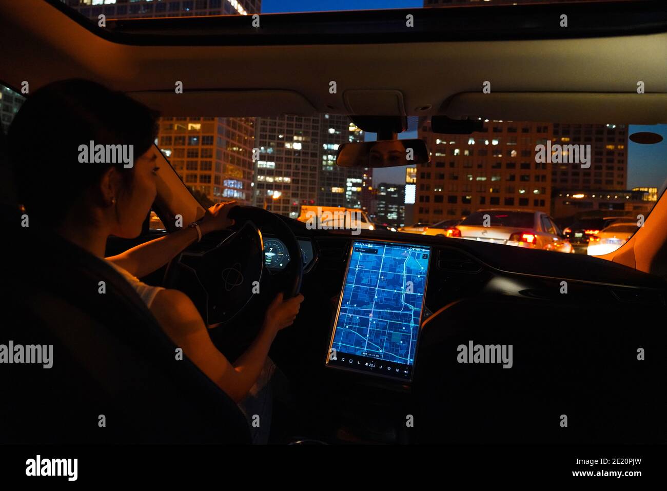 Driving at night young woman Stock Photo - Alamy
