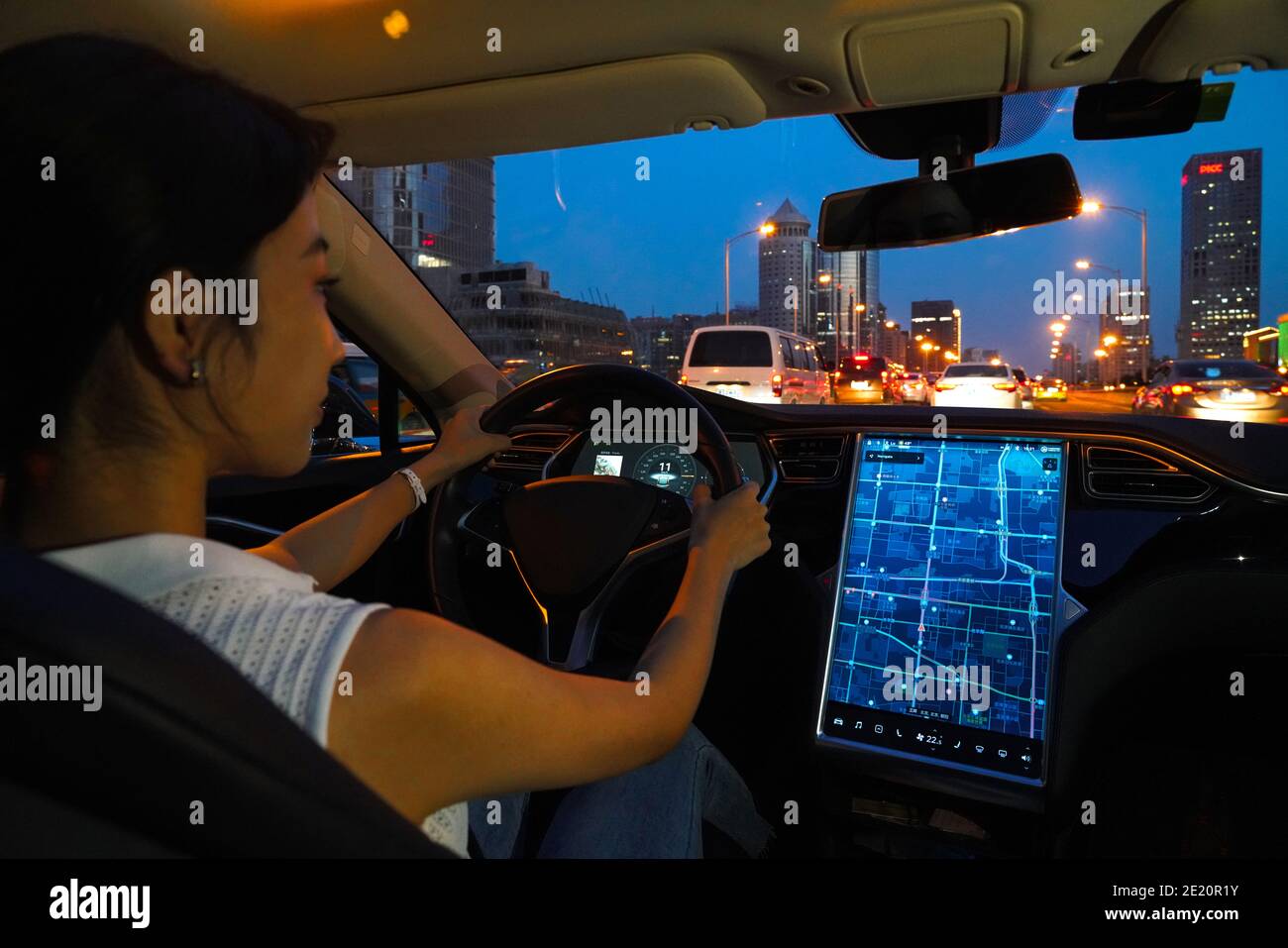Night driving young woman look at the screen navigation Stock Photo - Alamy