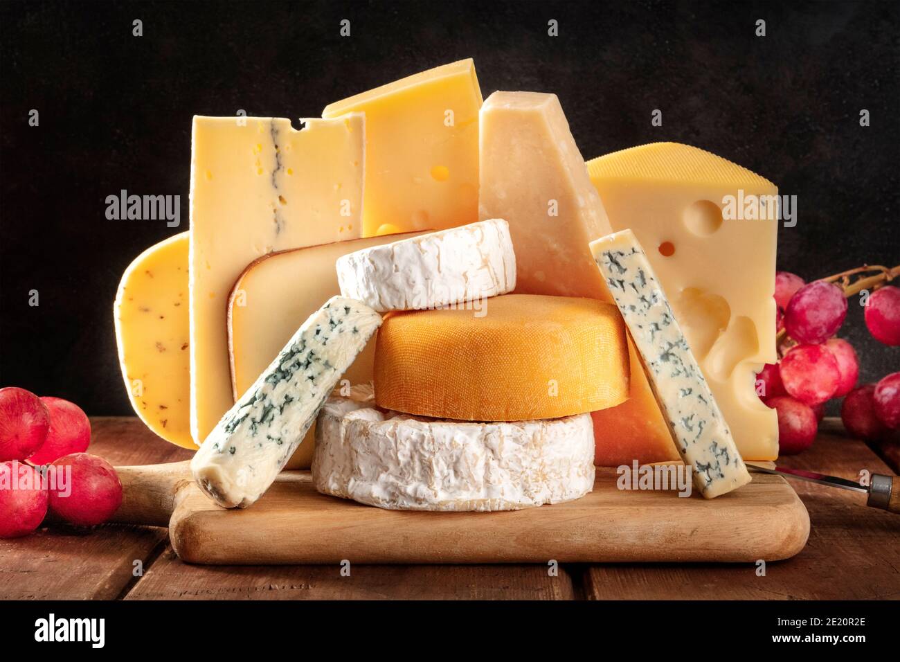 Cheese variety, many different types of cheeses, a close-up on a dark ...