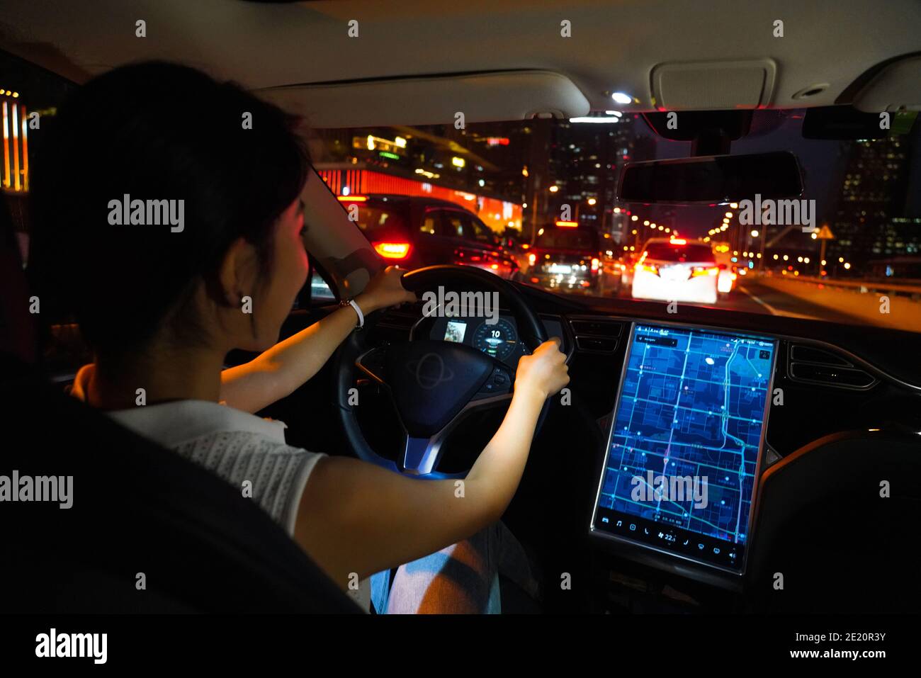 Driving at night young woman Stock Photo - Alamy