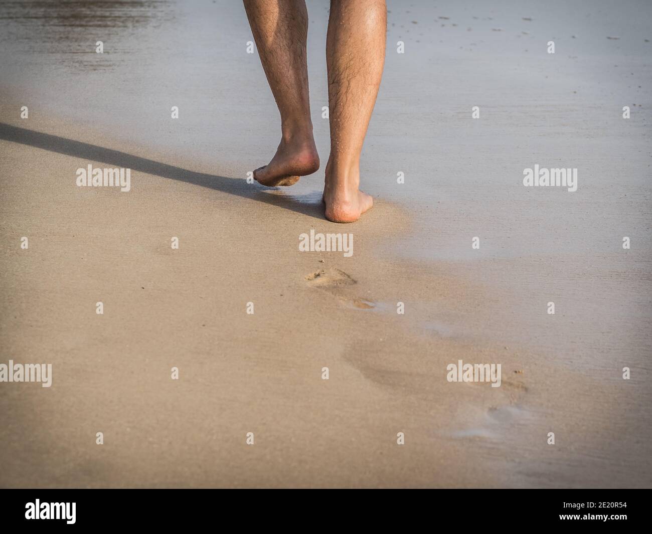 Beach man walking footprints hi-res stock photography and images - Alamy