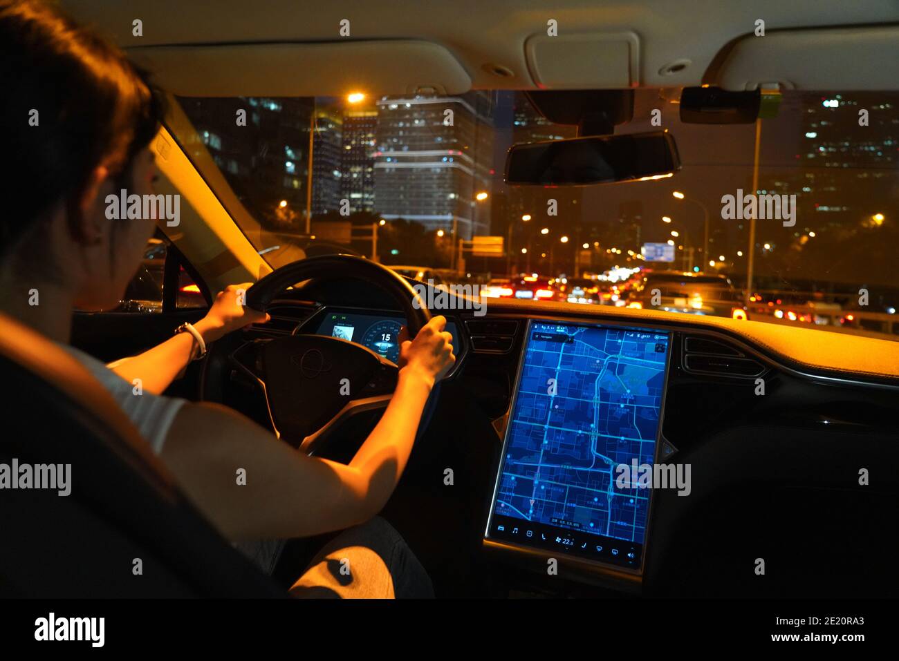 Night driving young woman look at the screen navigation Stock Photo - Alamy