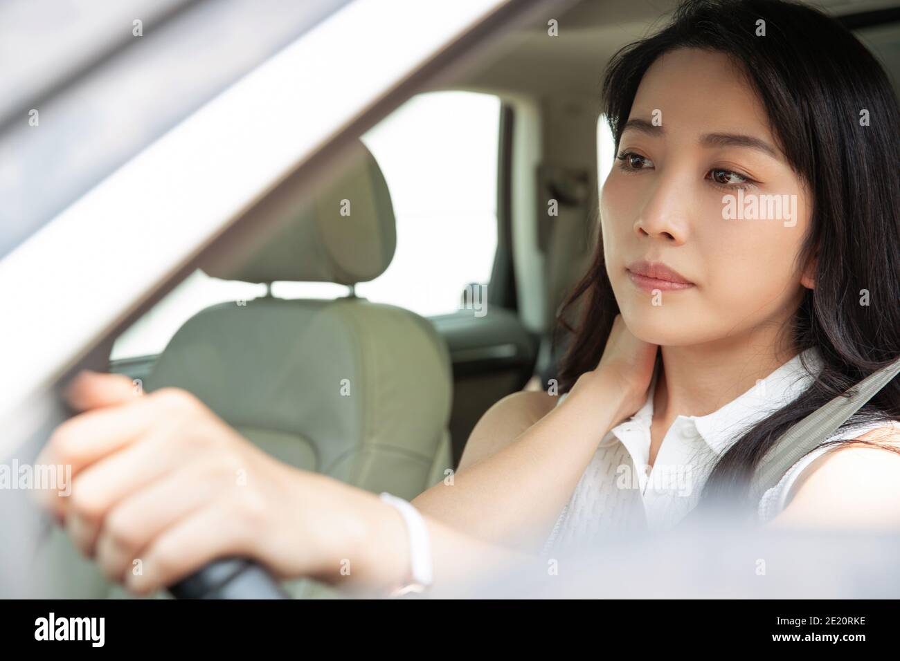 Tired of young woman driving Stock Photo - Alamy