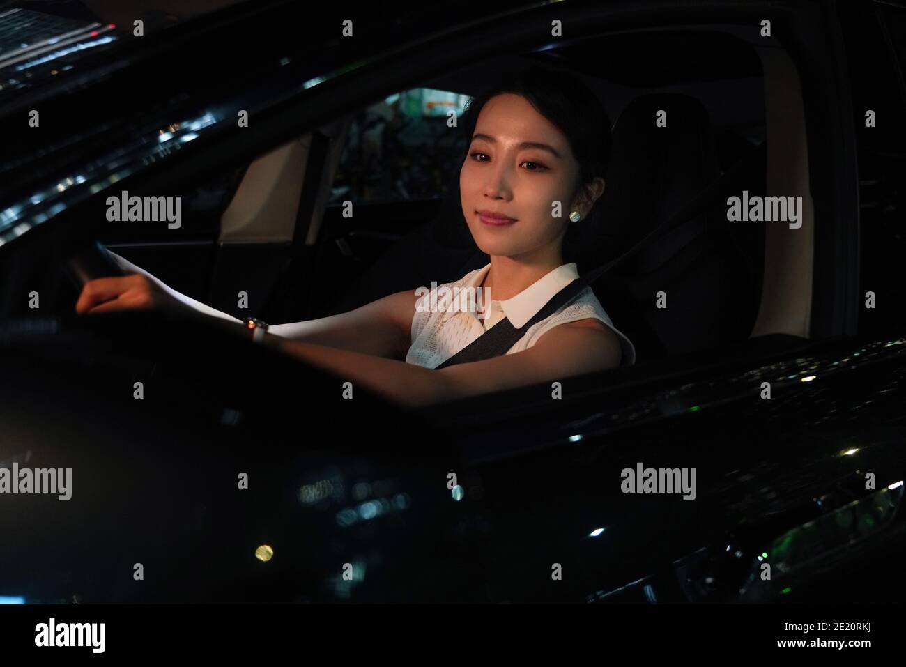 Driving at night young woman Stock Photo - Alamy