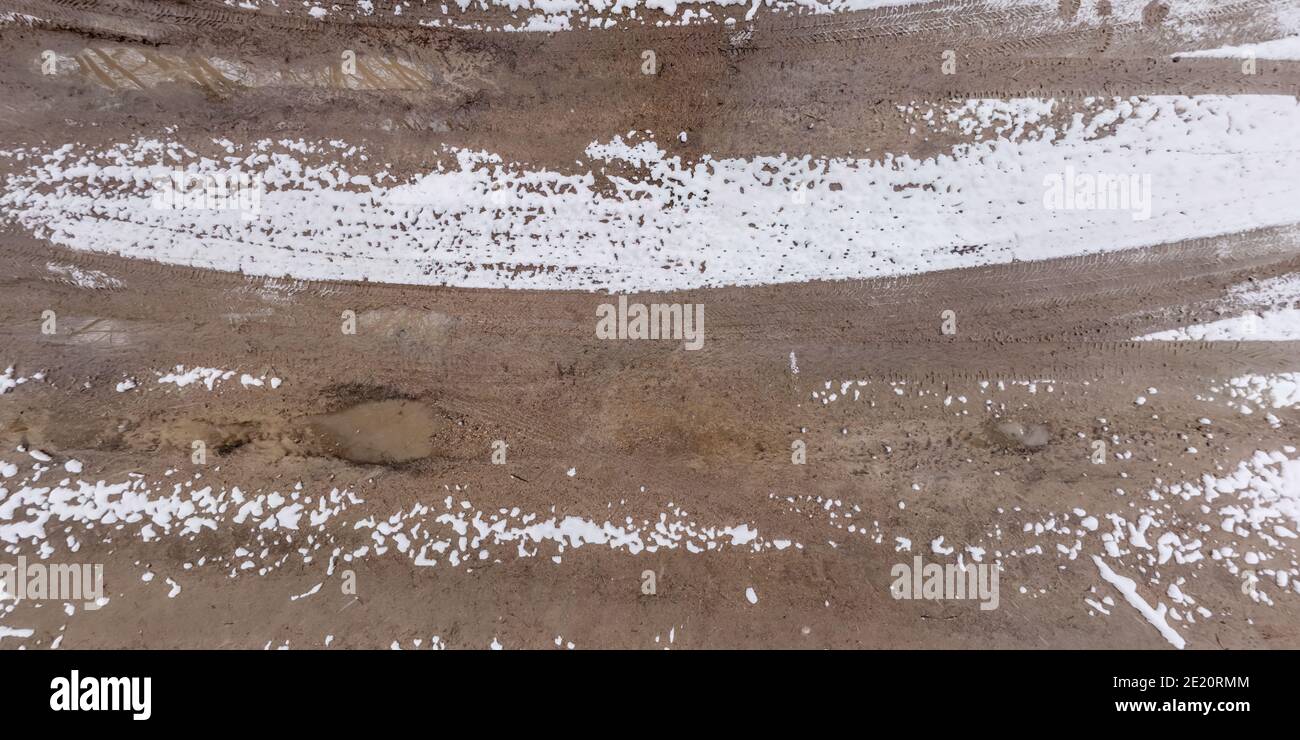panorama view from above on texture of snow covered gravel dirt road in ...
