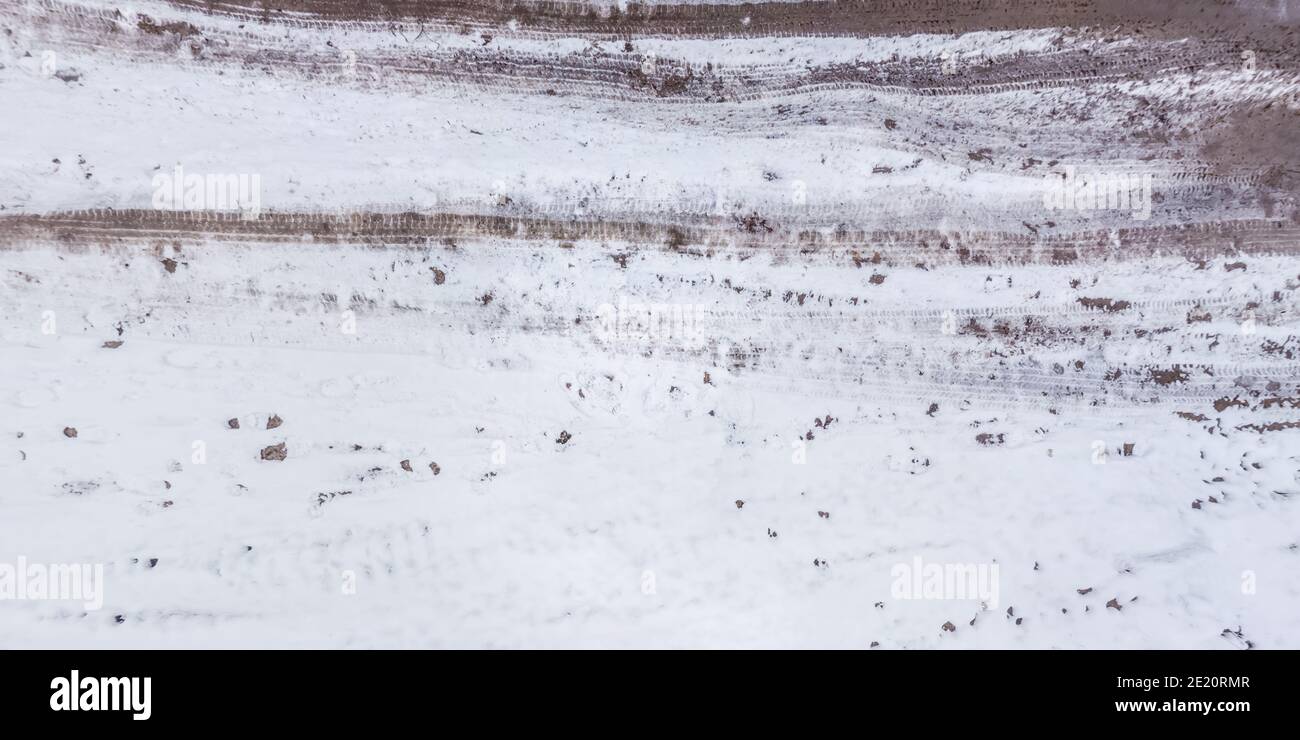 panorama view from above on texture of snow covered gravel dirt road in ...