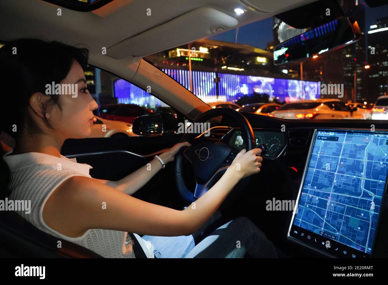 Driving at night young woman Stock Photo - Alamy