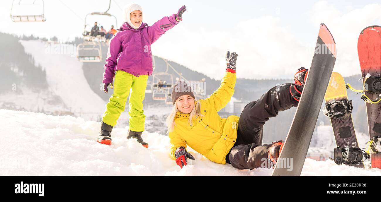 family with snowboards at winter resort Stock Photo - Alamy