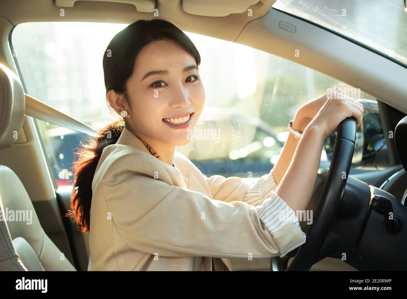 Happy young woman driving a car Stock Photo - Alamy