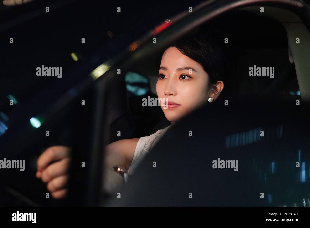 Driving at night young woman Stock Photo - Alamy