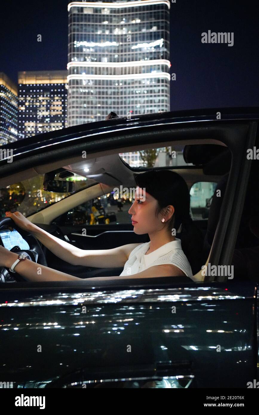 Driving at night young woman Stock Photo - Alamy