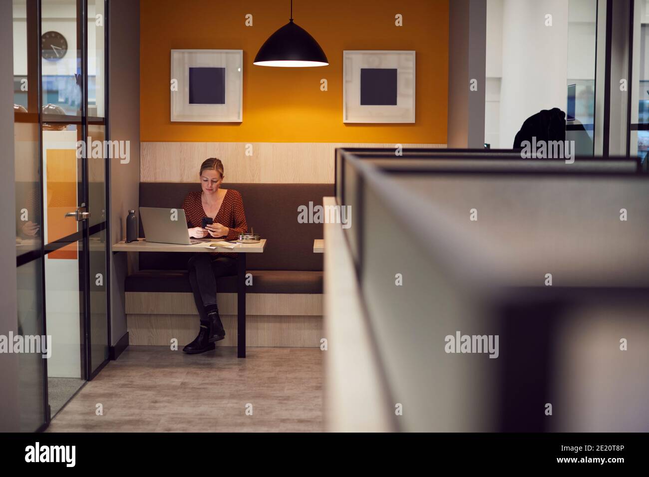 Businesswoman Working Late In Open Plan Office Using Laptop Stock Photo ...