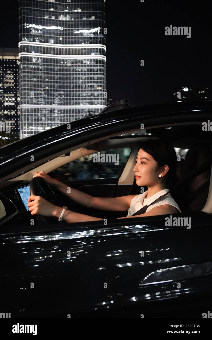 Driving at night young woman Stock Photo - Alamy