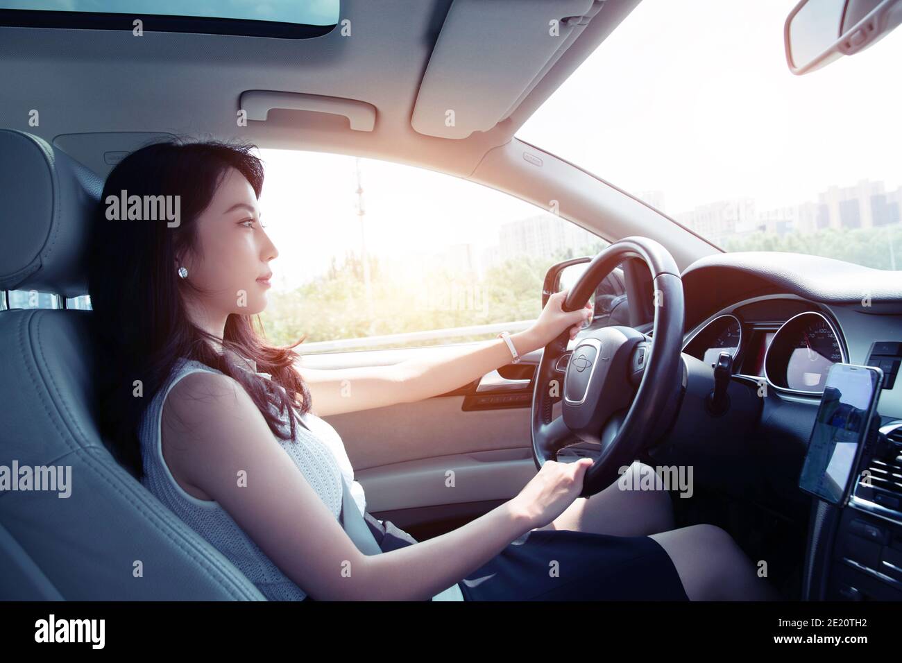A beautiful young woman driving Stock Photo - Alamy