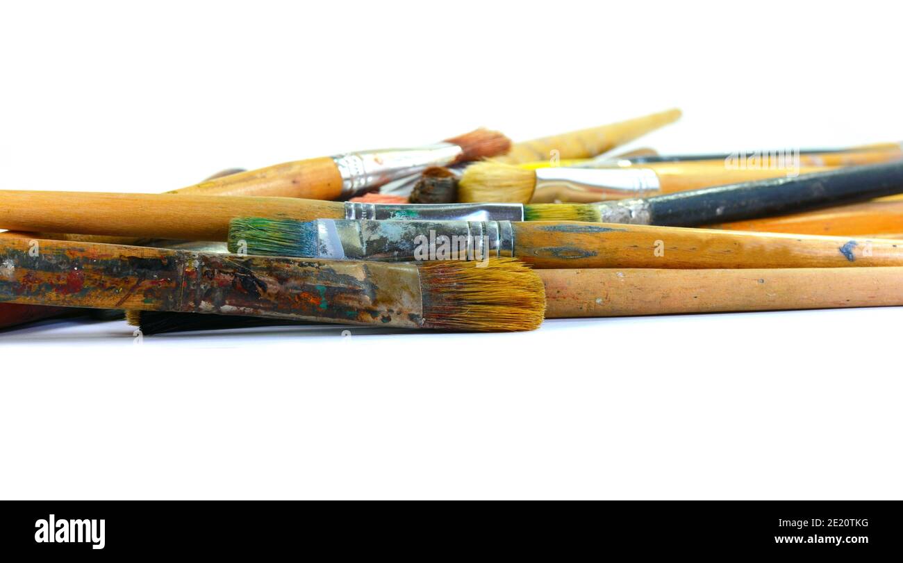 Various dirty paint brushes. Paints and brushes isolated on white ...