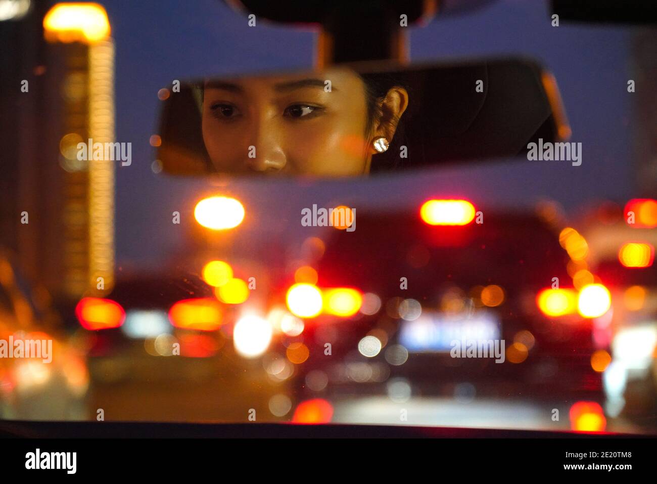 Car rearview mirror display of young women Stock Photo - Alamy