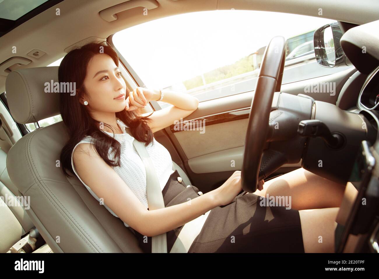 A beautiful young woman driving a car Stock Photo - Alamy
