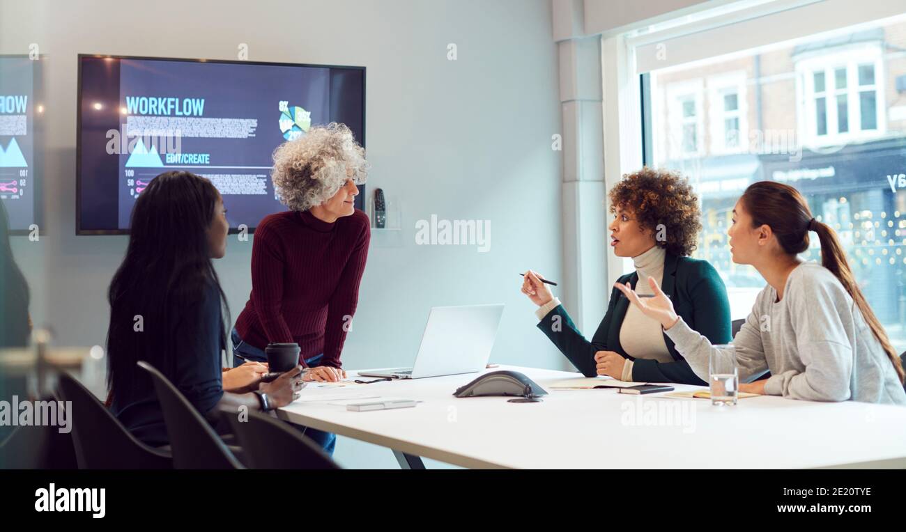 Mature Businesswoman Leading Creative Meeting Of Women Collaborating ...