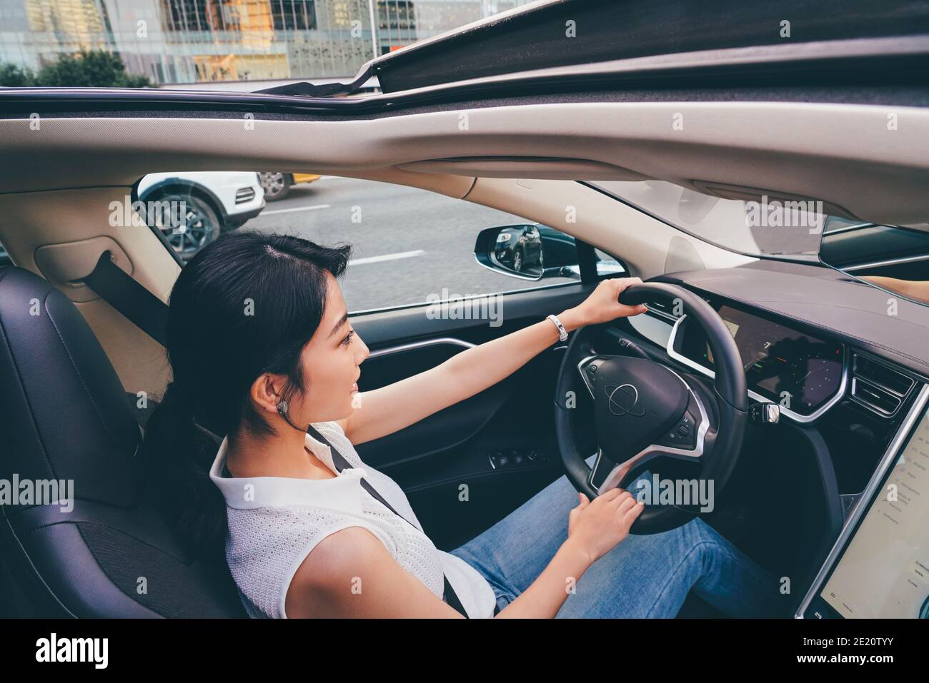 Driving the beautiful young woman Stock Photo - Alamy