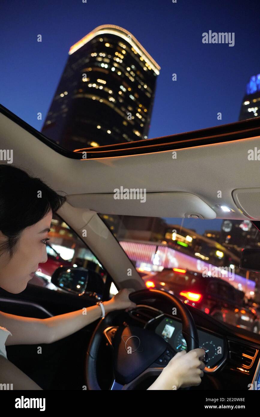 Driving at night young woman Stock Photo - Alamy