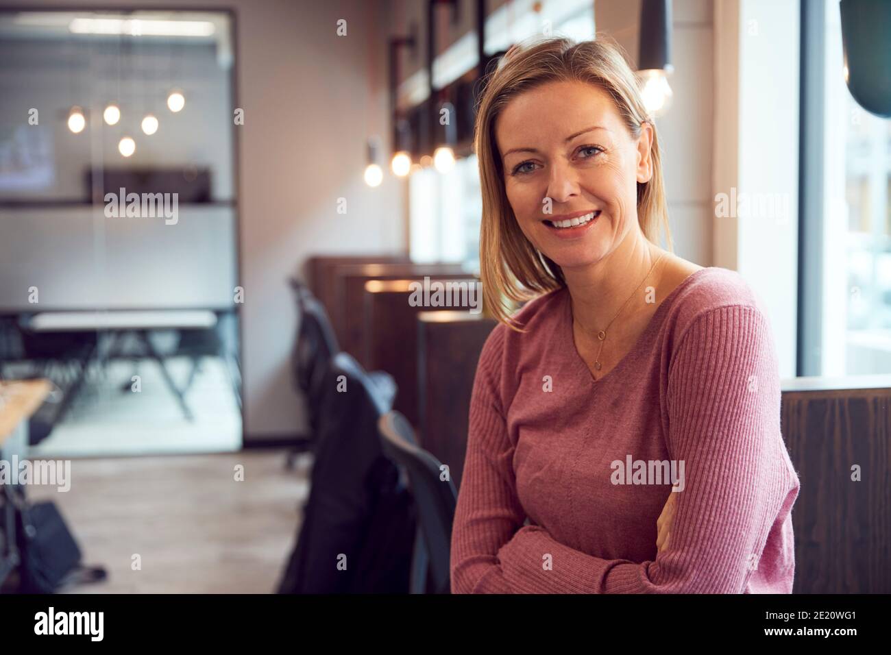 Head And Shoulders Portrait Of Smiling Mature Businesswoman Working In ...