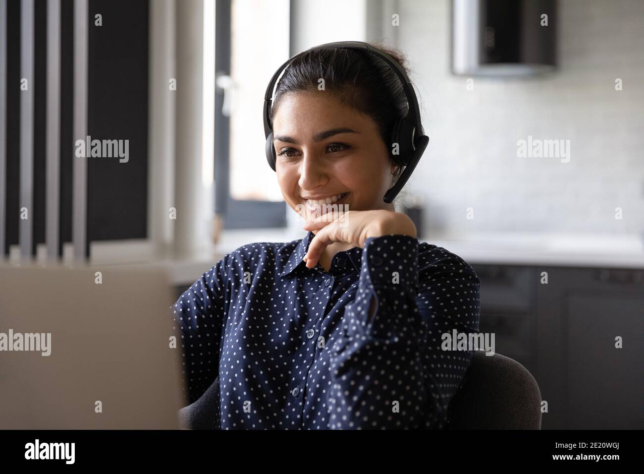 Smiling Indian woman in headset talk on video call Stock Photo - Alamy