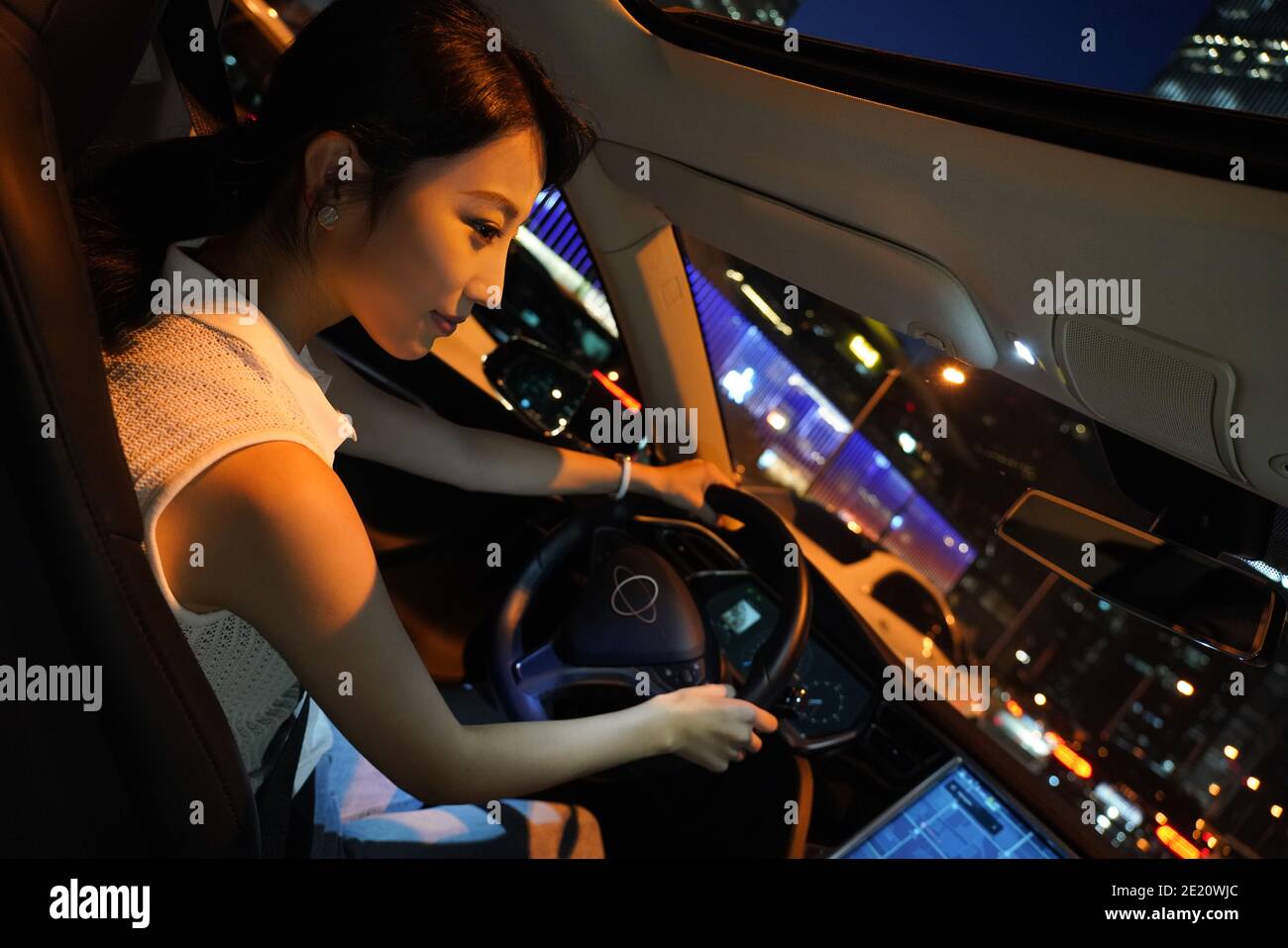 Driving at night young woman Stock Photo - Alamy