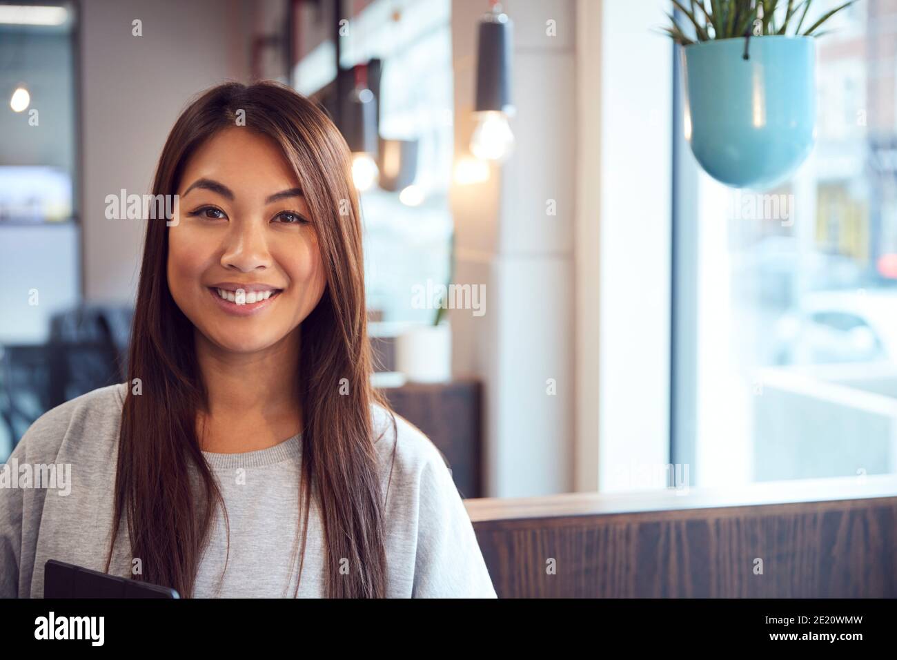 Head And Shoulders Portrait Of Smiling Young Asian Businesswoman Working In Modern Office Stock ...